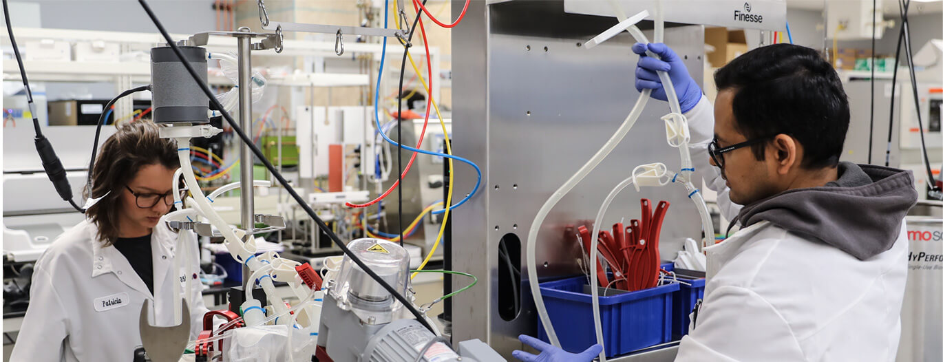 Employees working in the lab for the manufacturing process - AskBio